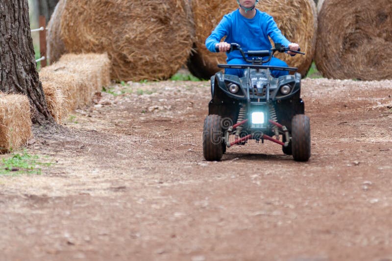 Child Riding Quad in the Forest on Holyday Period Stock Photo - Image ...