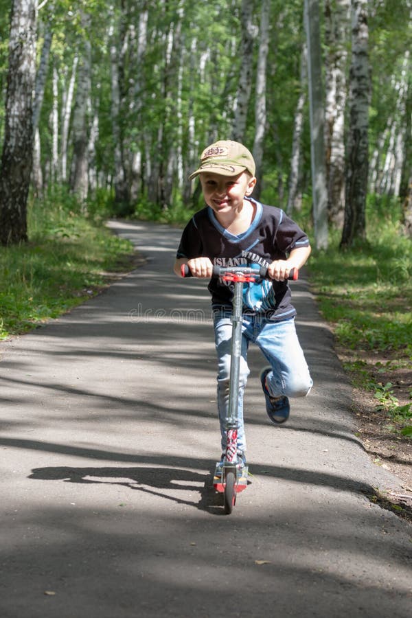Child riding a scooter stock image. Image of sport, lifestyle - 147674917