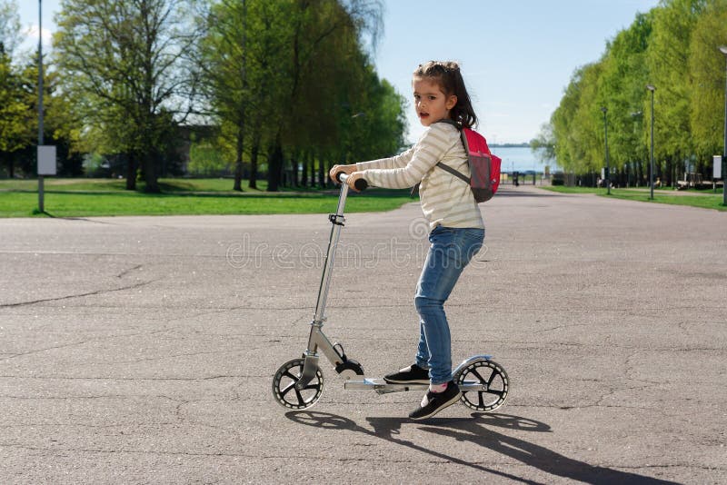 A Child is Riding a Scooter. Stock Image - Image of park, nature: 93284855