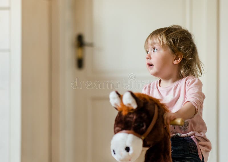 Child on rocking horse stock image. Image of horse, door - 77383949