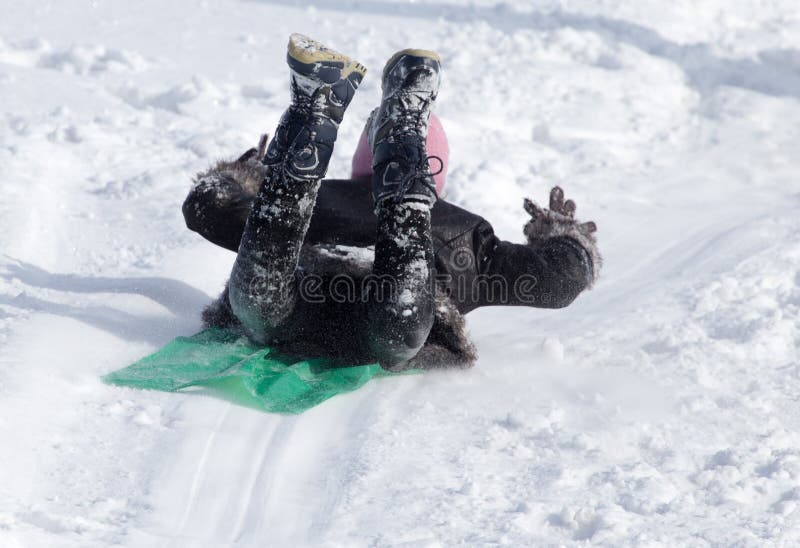 Child Rolls Down a Snow Hill. Boy Sliding Down Snow Hill in Winter ... Child Rolls Down a Snow Hill. Boy Sliding Down Snow Hill in Winter ...