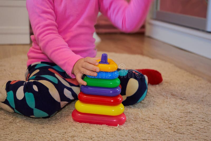 A Child is Playing with a Colored Pyramid,a Child in a Room Playing ...