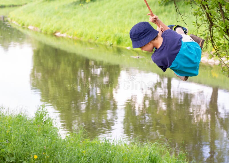Child on a rope swing stock photo. Image of green, action - 213017146