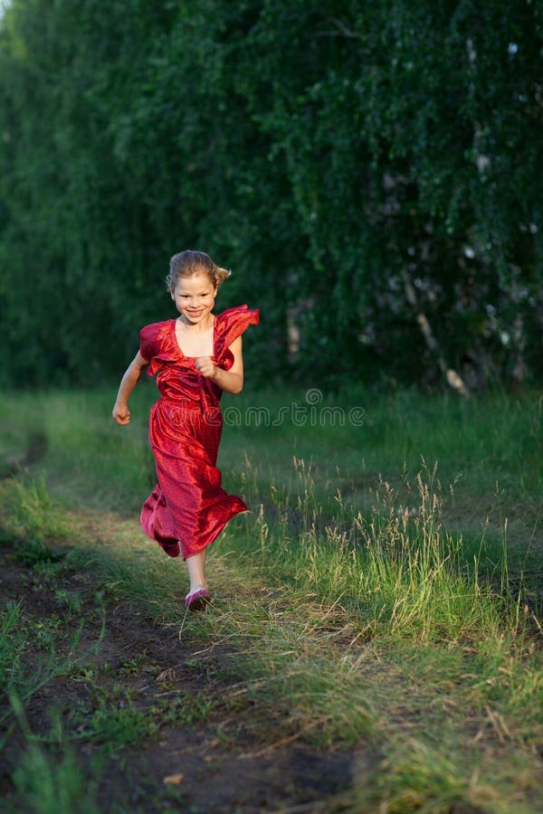 Child running in a field stock photo. Image of blue, forest - 74297156