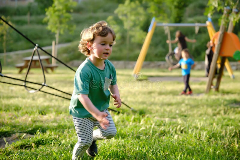 Child Running on a Playground Stock Image - Image of enjoyment, emotion ...
