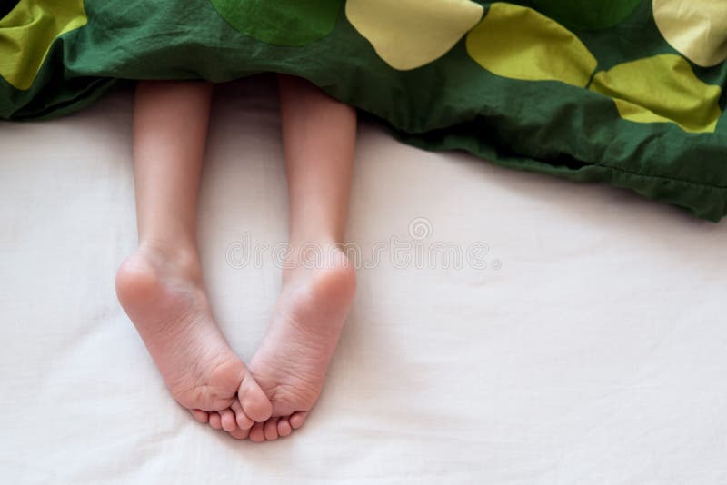 Child s feet under blanket stock image. Image of human - 79115083