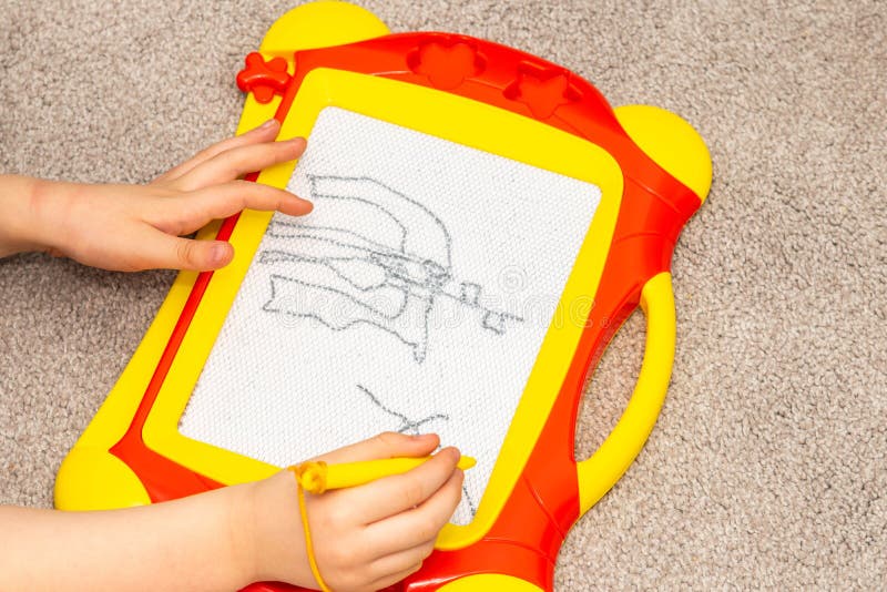 Child`s Hand Drawing on Educational Drawing Board that is Magnetic ...