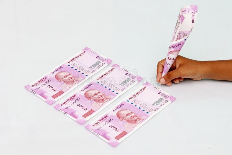 Child`s Hand Hold 2000 Rupee Note Just Like a Pen. Stock Image - Image ...