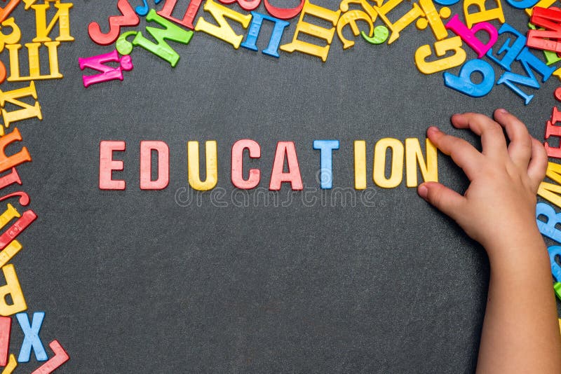 Child`s Hand Laid Out the Word Education from Multicolored Plastic ...