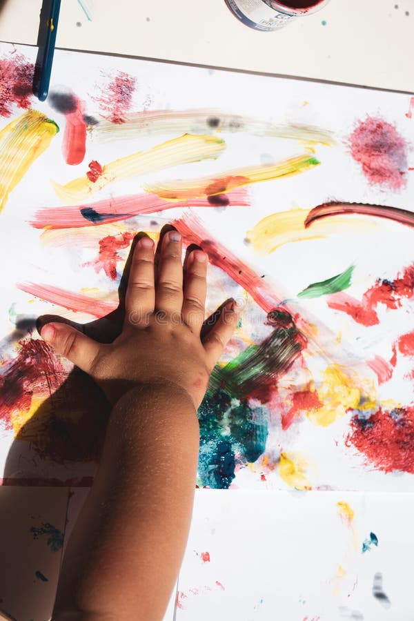 Child S Hand Making His Mark on Paper Painted with Tempera Stock Photo ...