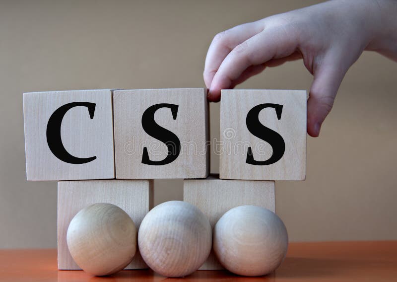 A Child S Hand Places a Large Cube Next To Other Cubes. CSS Acronym ...