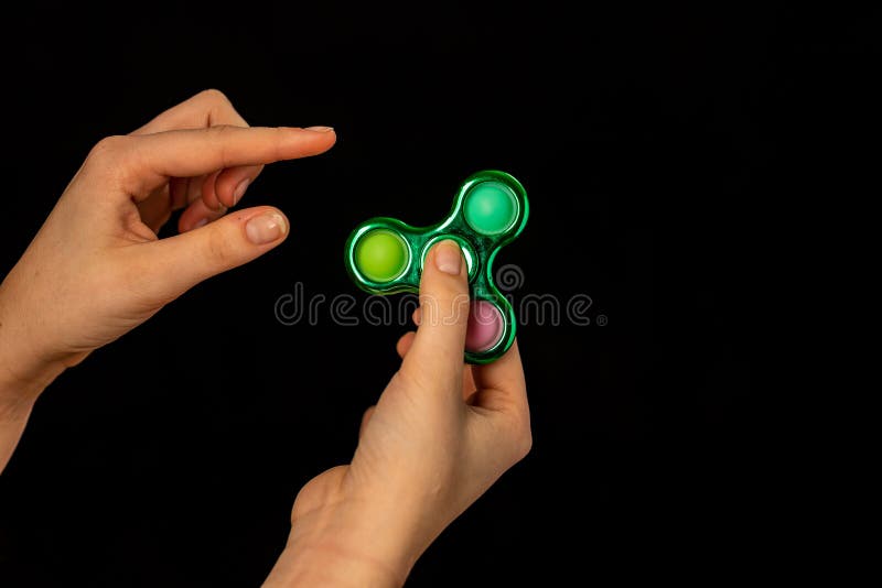 Child`s Hand Playing with a Fidget Spinner Toy Stock Photo - Image of ...