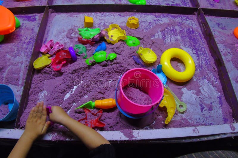 A Child S Hand is Playing with Purple Sand Stock Image - Image of ...