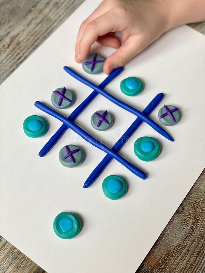 A Child`s Hand is Playing a TIC TAC Toe Board Game Stock Photo - Image ...