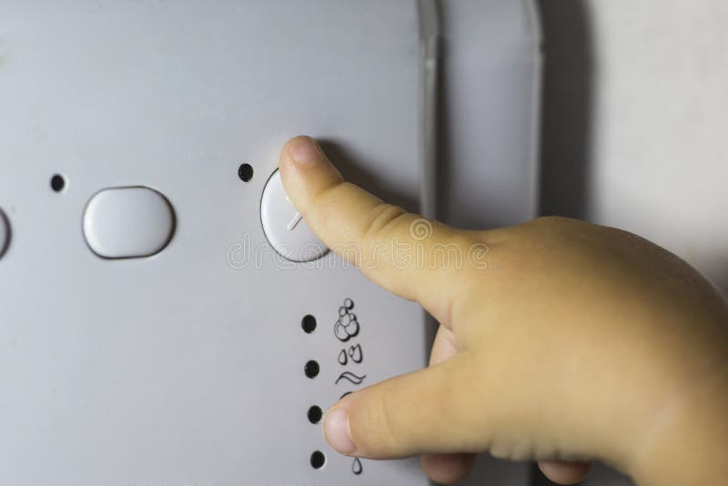 A Child& X27;s Hand Presses a Button on a Washing Machine Stock Photo ...
