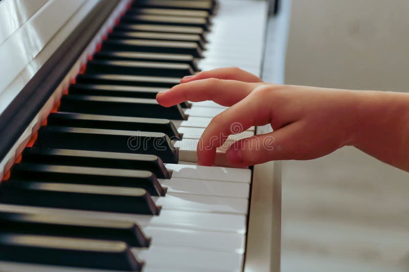 Child& X27;s Hand Pressing Keys on Piano Stock Image - Image of ...