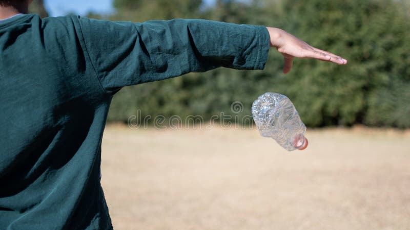 Child S Hand Throwing a Plastic Bottle in Nature Stock Image - Image of ...