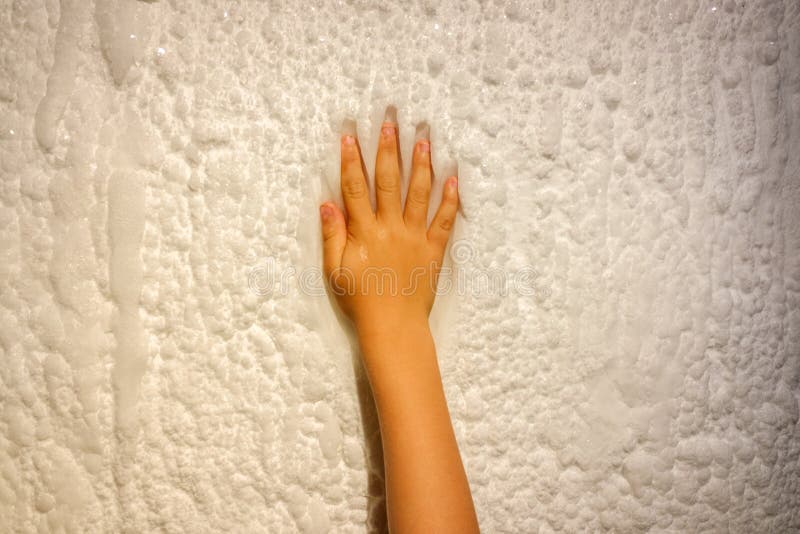 A Child`s Hand Touching the Frozen Ground Full of Ice Stock Image ...