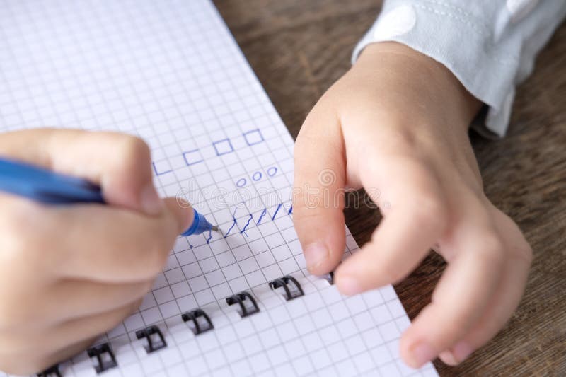 Child S Hand Writes with Pen in Notebook, Practicing Handwriting for ...
