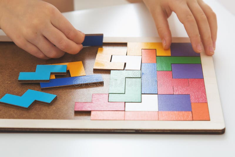 Child S Hands Assembling a Colorful Wooden Puzzle with Geometric Pieces ...