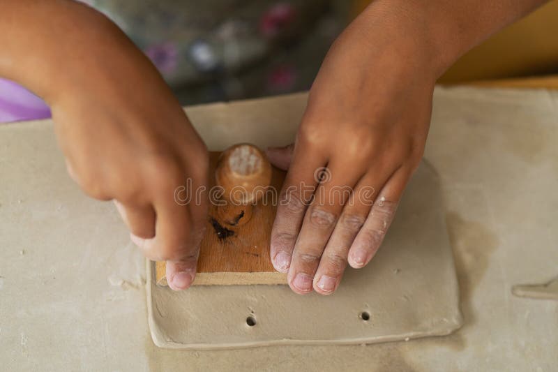 Child S Hands in Pottery-making Process, Pressing Wooden Tool into Soft ...