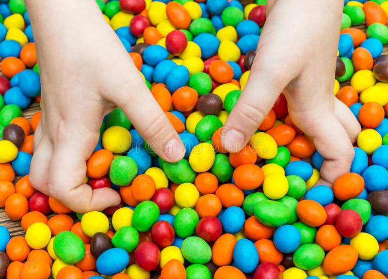 Child`s Hands Taking Sweet Round Candies from the Table Stock Photo ...