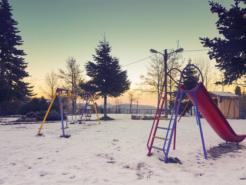 Child`s Playground with Snow at Sunset. a Beautiful Lonely Environment ...