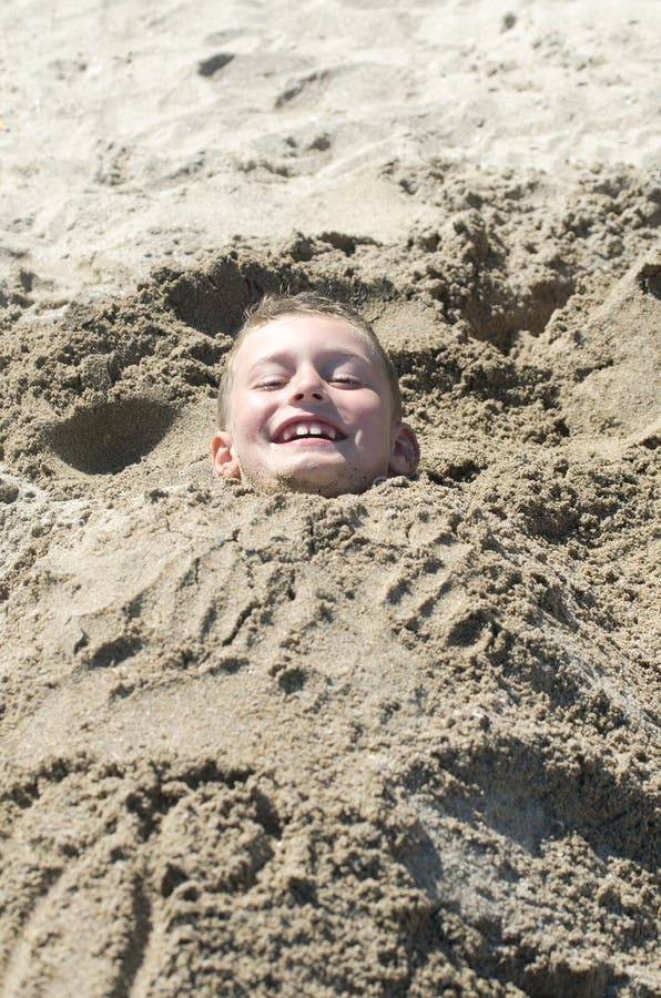 Little girl dug into sand stock photo. Image of little - 72866788