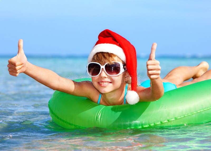 Child in Santa Hat Floating on Inflatable Ring. Stock Photo - Image of ...