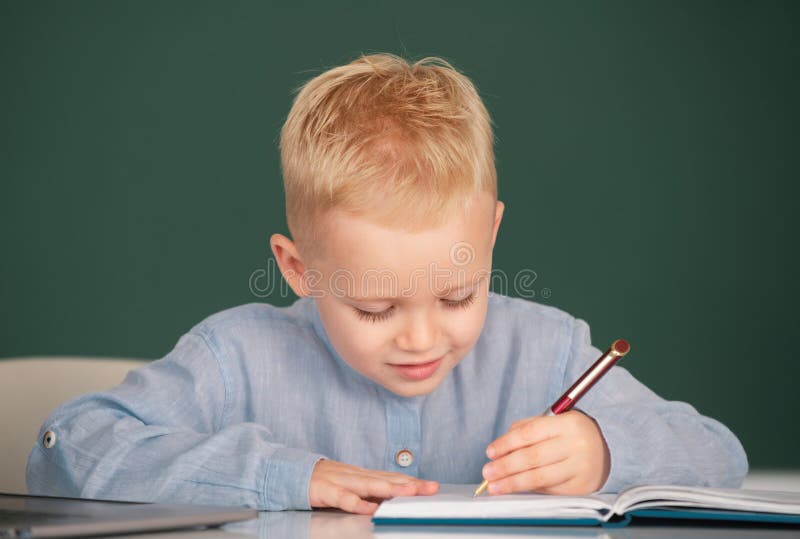 Kid Writing in Class. Child at School. Kid is Learning in Class on ...