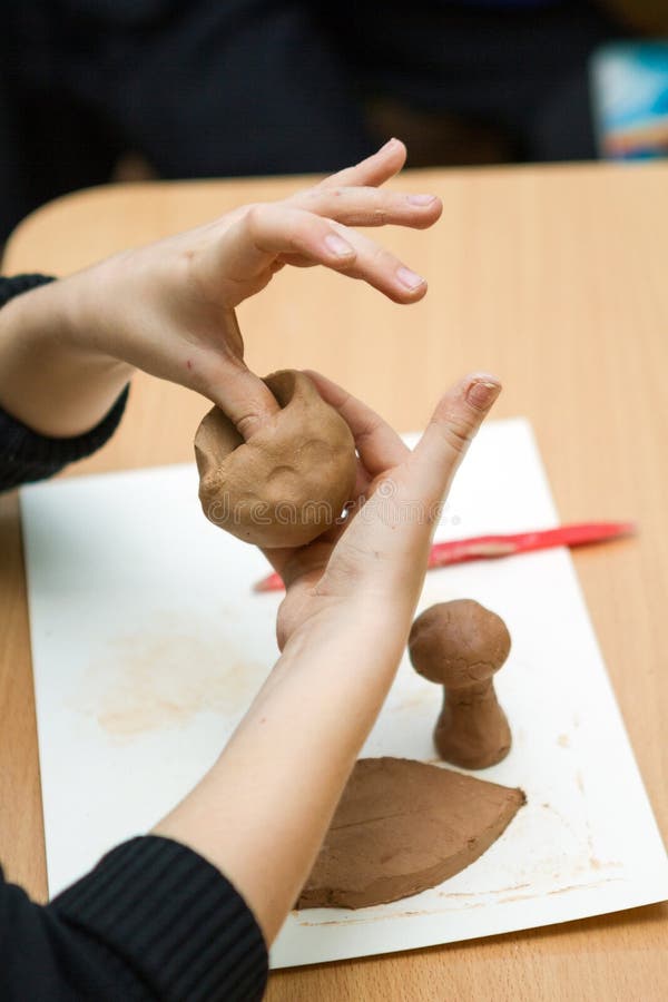Child sculpts from clay. stock image. Image of classmates - 63208961