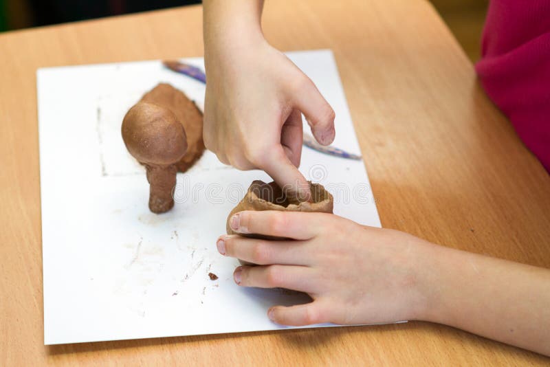 Child sculpts from clay. stock image. Image of classmates - 63208971