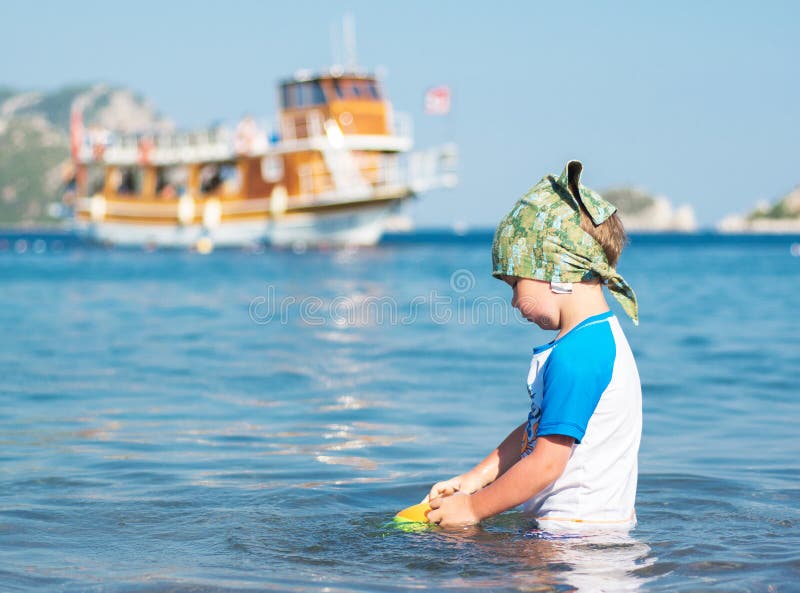 Child on the sea coast stock image. Image of games, holidays - 135432447