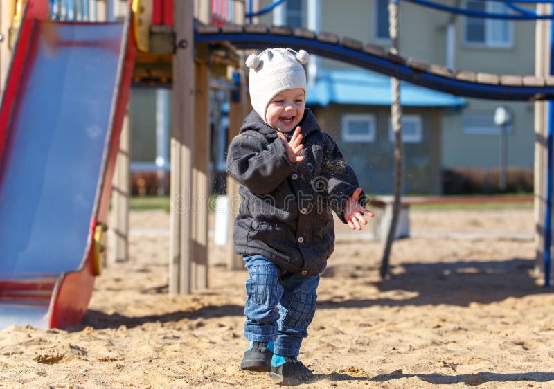 Child Shakes Off His Hands from the Sand on Playground Stock Image ...