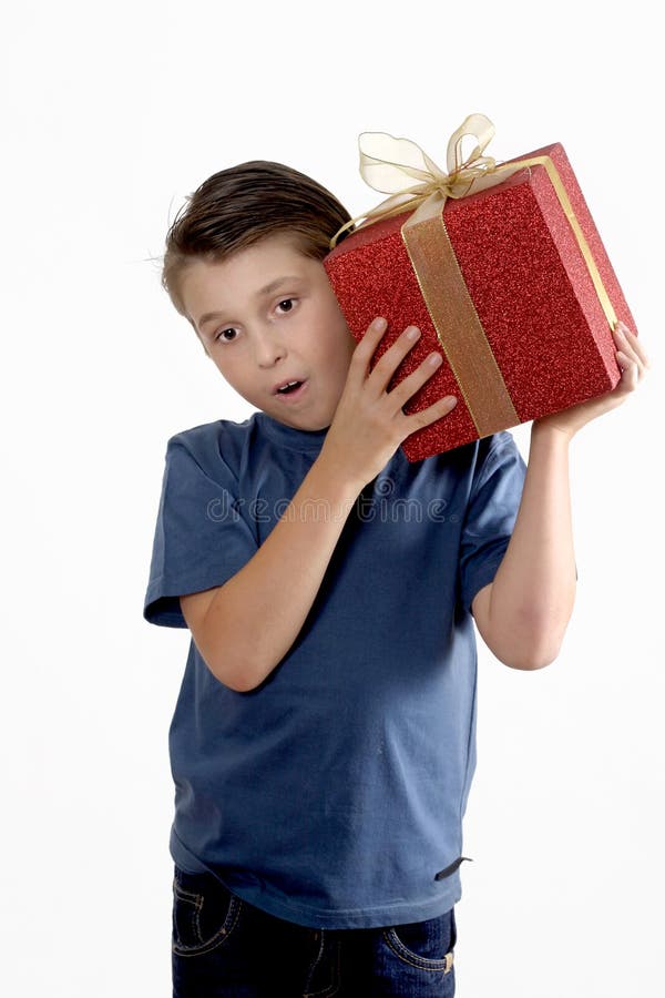 Child Shaking a Wrapped Present Stock Photo - Image of gifts, gold: 1248656