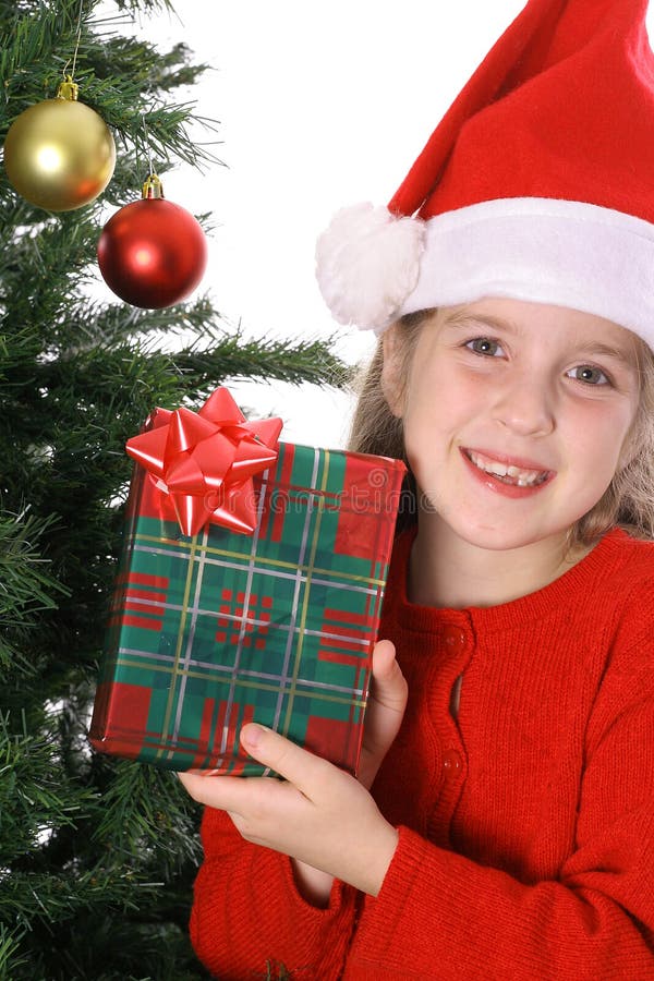 Child Showing a Present by the Christmas Tree Stock Photo - Image of ...