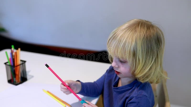 Young Child Engages in Creative Drawing Activity with Colorful Markers ...