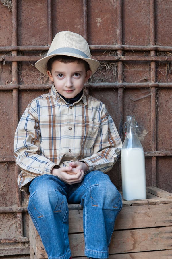 Child Sitting on a Box with a Bottle of Fresh Milk Stock Photo - Image ...