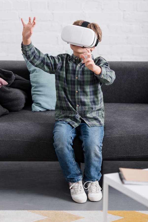 Child Sitting on Couch and Using Virtual Reality Headset Stock Photo ...