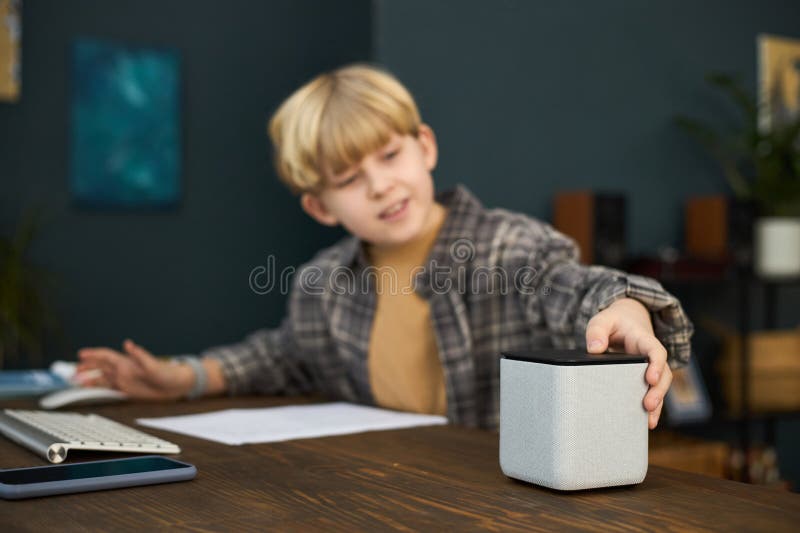 Young Boy Using Smart Speaker Device at Home Desk Stock Image - Image ...