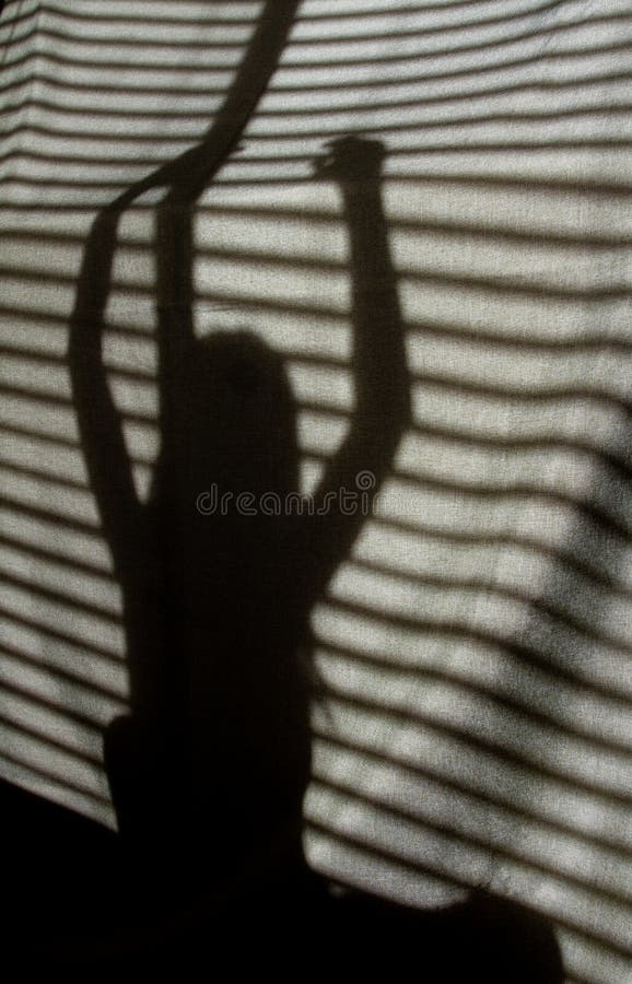 Shadow of Young Child Against a Cloth Background in Front of Blinds ...