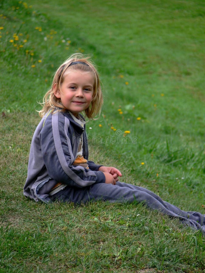 Child sitting on the grass stock photo. Image of play - 3150174