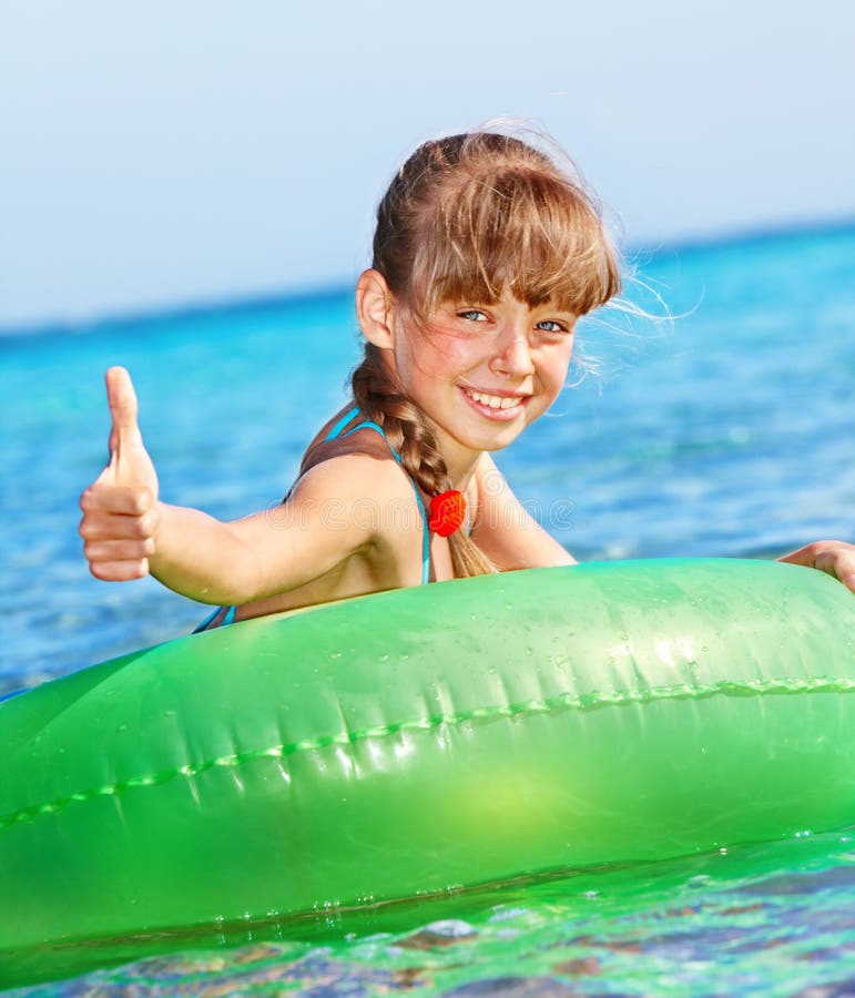 Child Sitting on Inflatable Ring Thumb Up. Stock Image - Image of ...