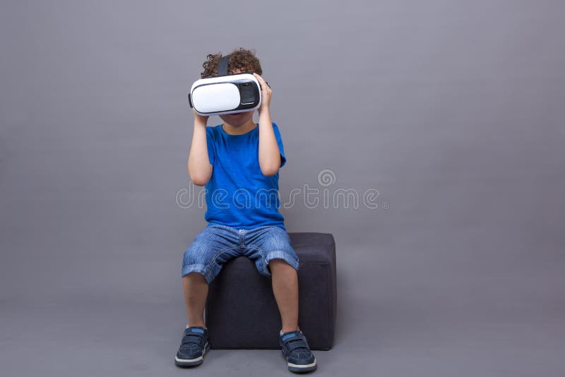Child Sitting and Playing with Virtual Reality Goggles Stock Photo ...