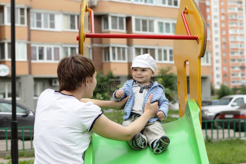 Child sitting on slide stock image. Image of female, cheerful - 25910265