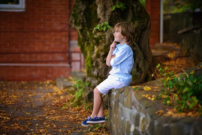 Child Sitting Under Big Tree Stock Photo - Image of outside, astonished ...