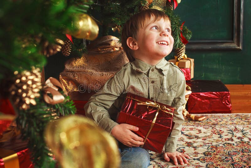 Child Sitting Under the Christmas Tree with Gifts Stock Image - Image ...