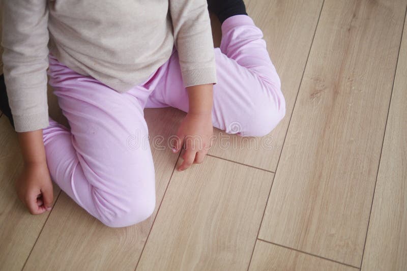 Child Sitting on W Shape on a Wooden Floor Stock Image - Image of shape ...