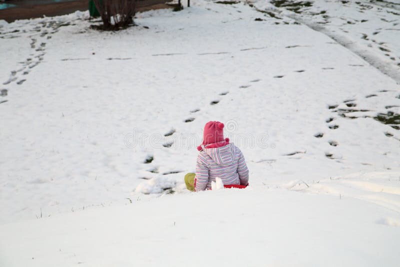 A Child on a Sled Goes Down a Snow Slide Stock Image - Image of move ...