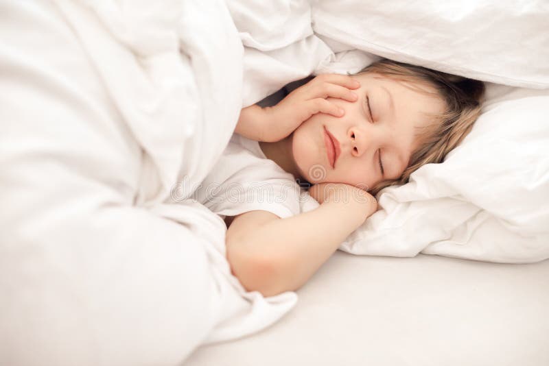 Child sleeping in bed stock image. Image of asleep, morning - 98409719